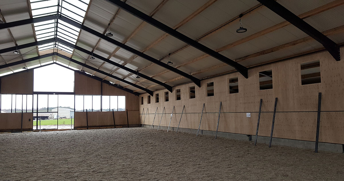 Plywood walling and a wooden frame for a horseback riding arena